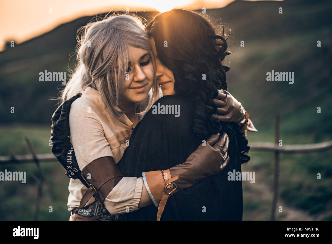 Fantasy cosplay two beautiful girls hug in nature Stock Photo - Alamy