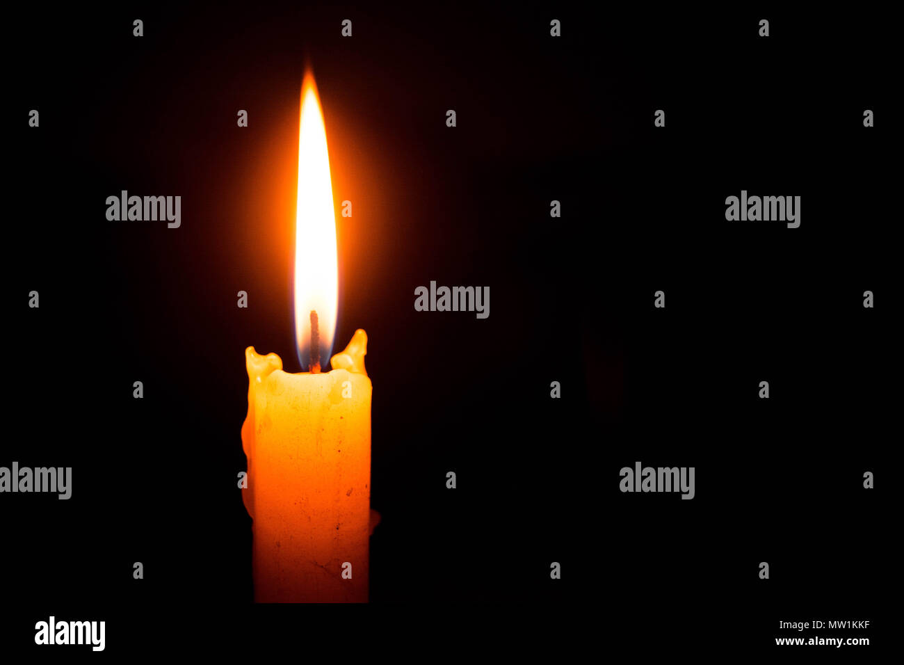 Single lit candle with quite flame Stock Photo - Alamy