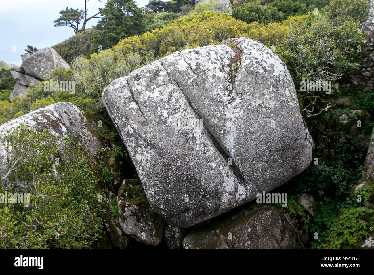 Large gray boulder with a crack in the middle inside the perimeter of ...