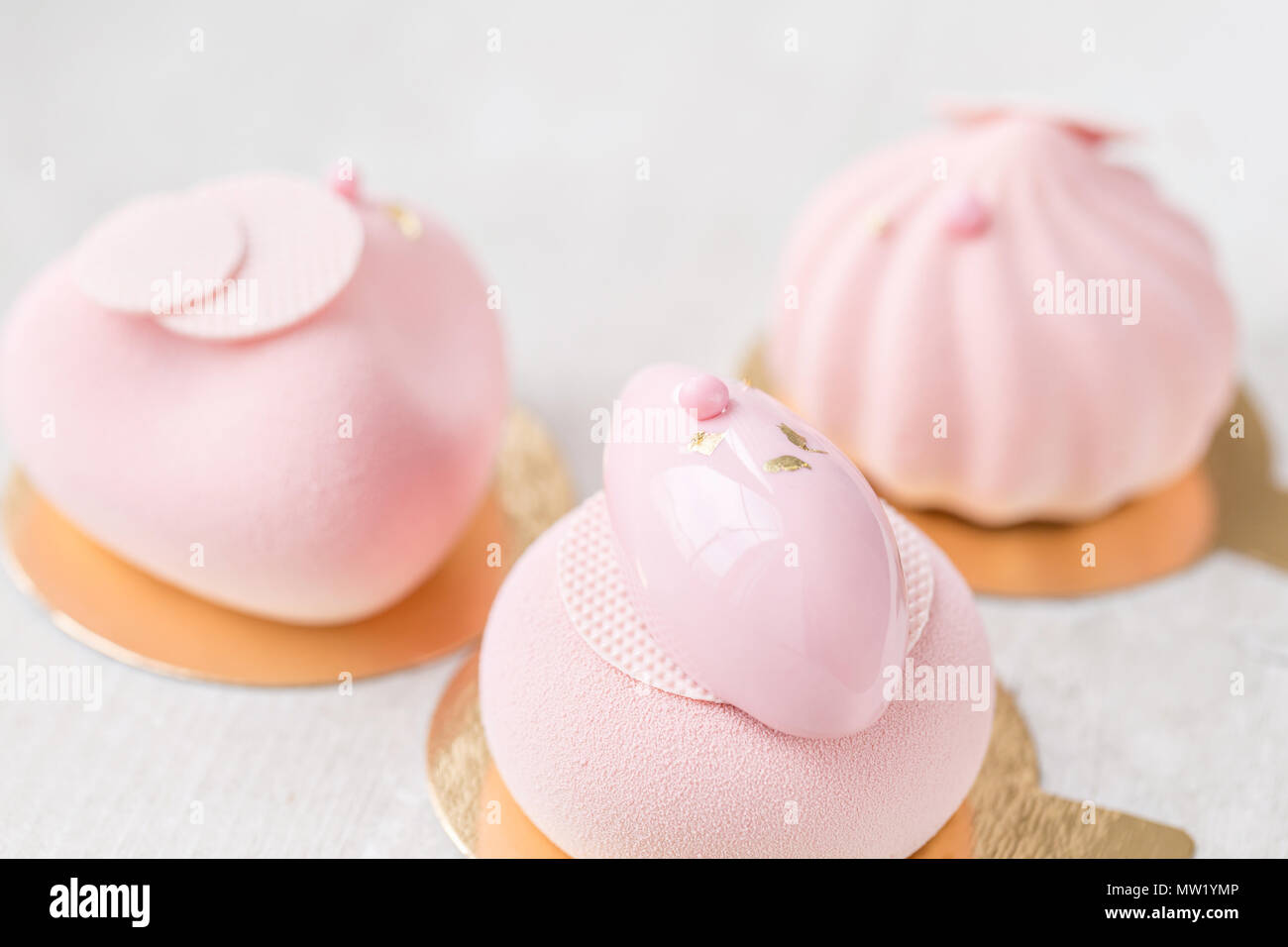 Pink mousse-cake. French dessert and flowers eucalyptus on a white ...