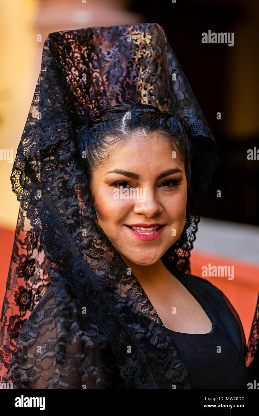 A women in a traditional mantilla in the ORATORIO CHURCH courtyard get ...