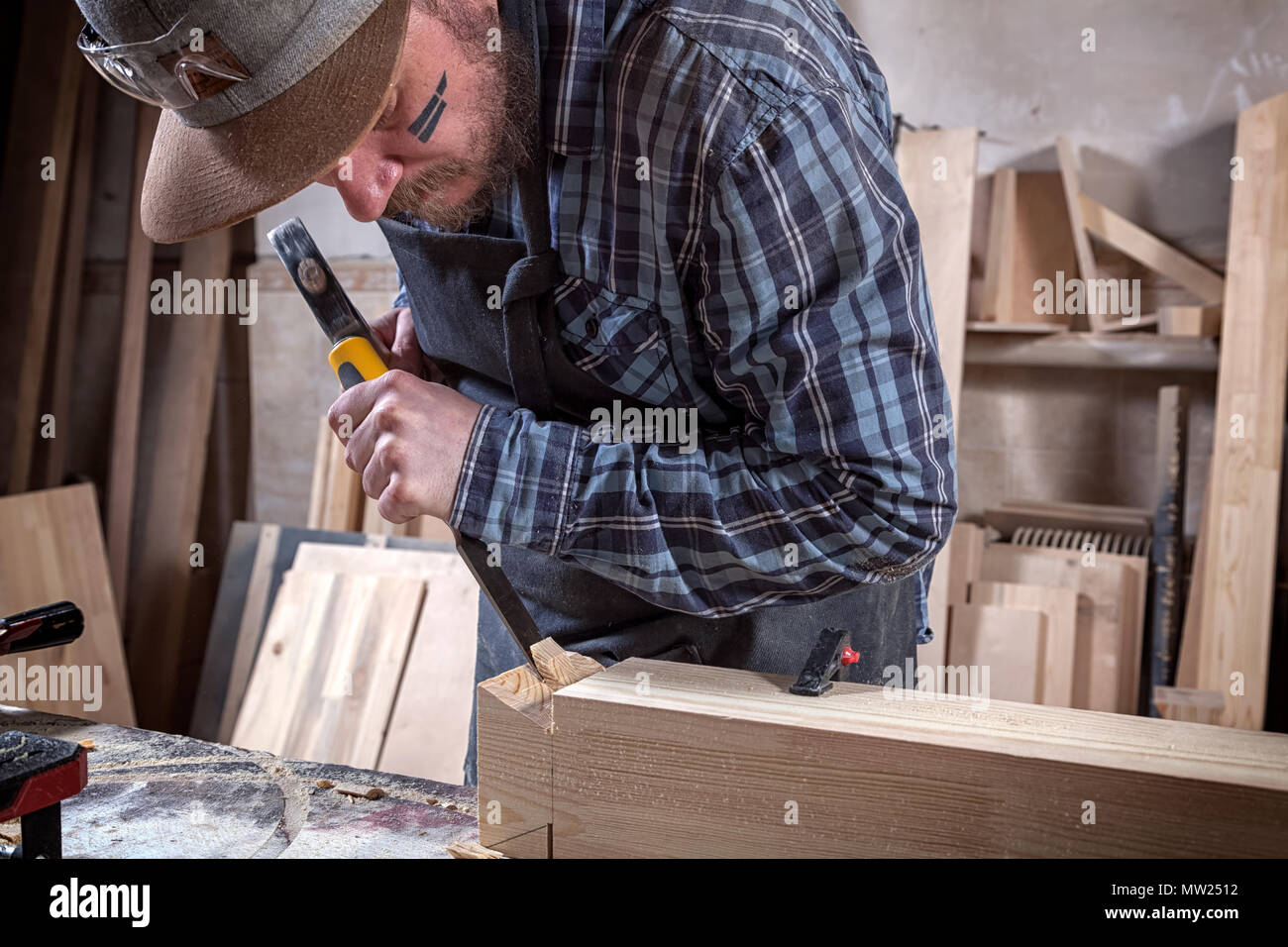 Close up experienced carpenter in work clothes and small buiness owner ...