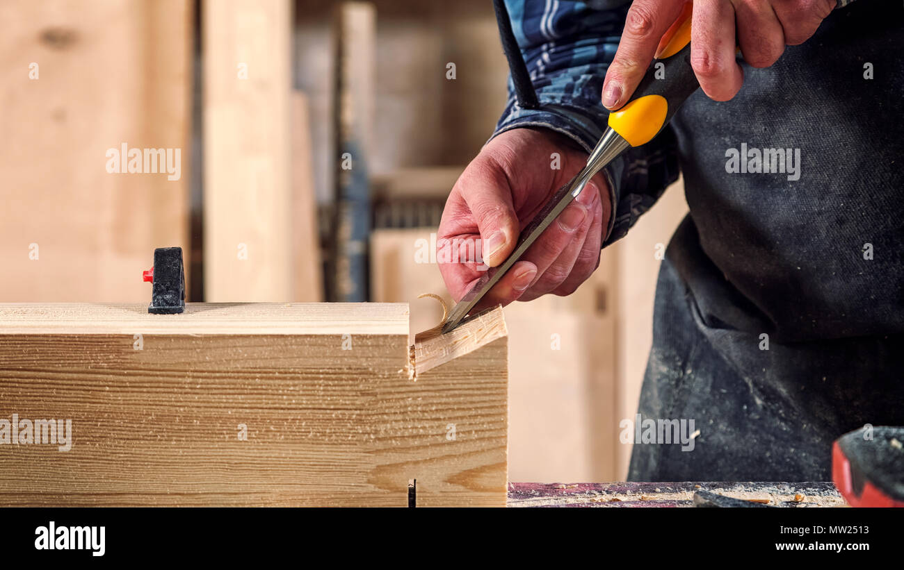 Close up experienced carpenter in work clothes and small buiness owner ...