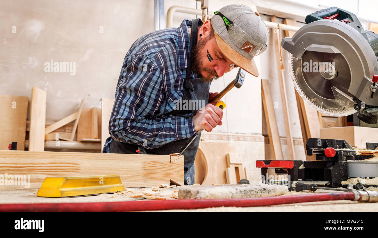 Close up experienced carpenter in work clothes and small buiness owner ...