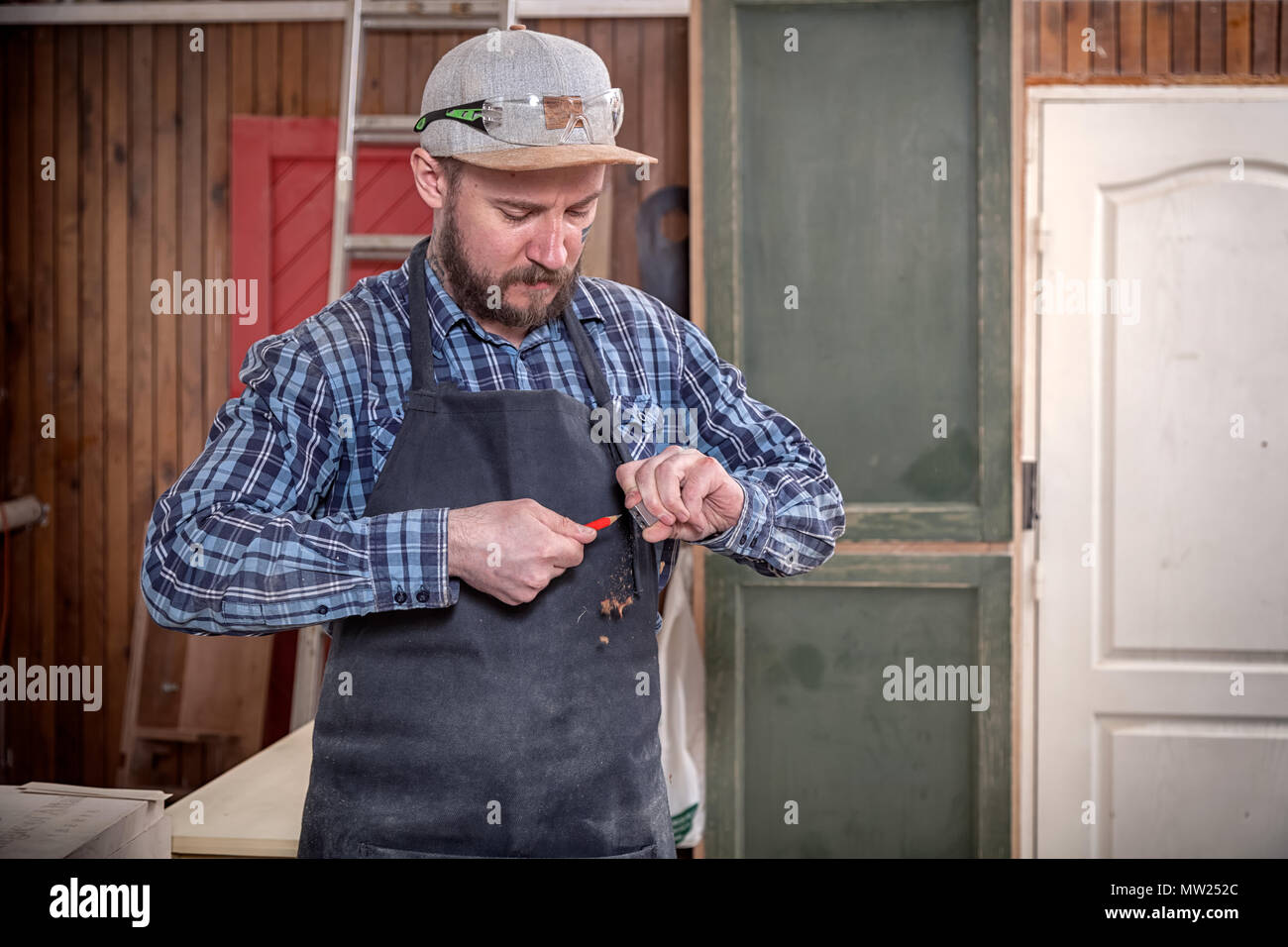 Close up experienced carpenter in work clothes and small buiness owner ...