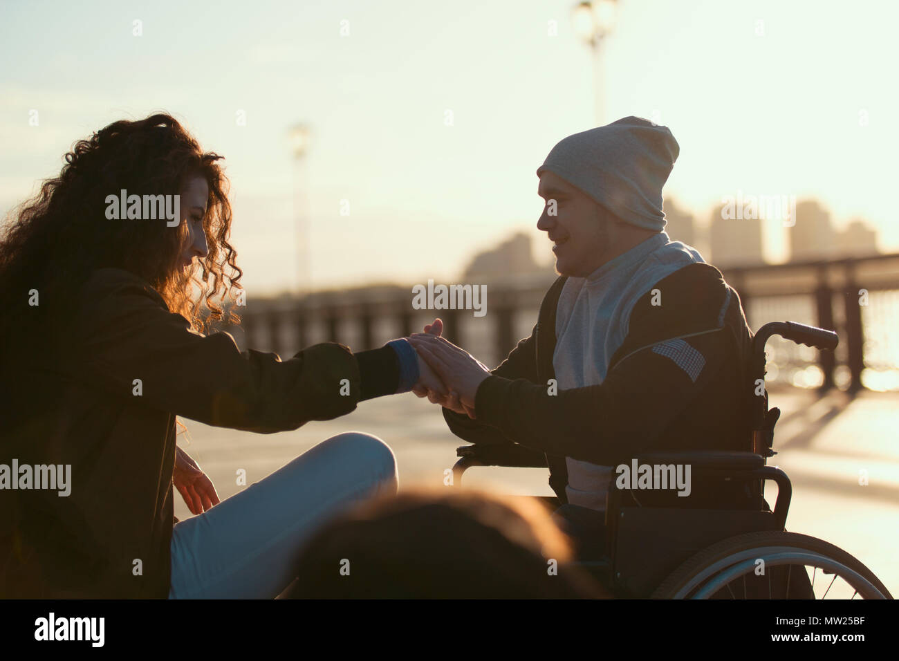 Young disabled man in wheelchair makes a proposal to his girlfriend on ...
