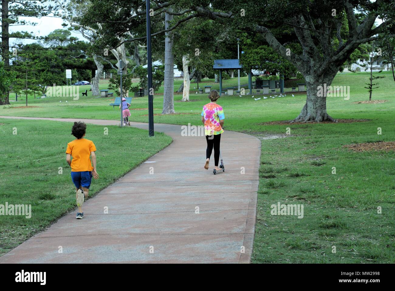 Children running in park. Kids playing in park Stock Photo - Alamy