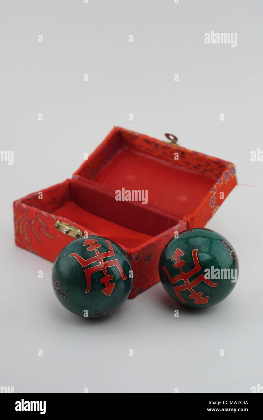 A set of red and green Chinese baoding balls with a traditional design ...