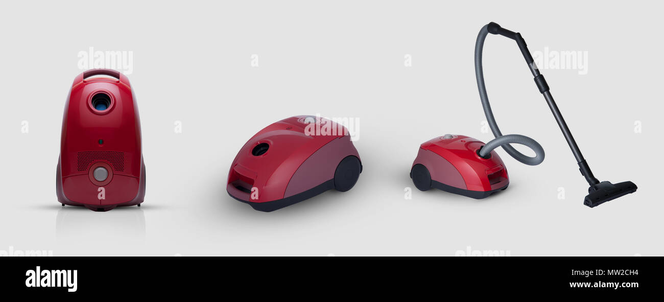 full view of a modern household vacuum cleaner of red color on a white ...
