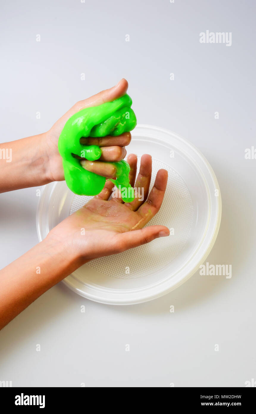 Slime, green pate elastic and vicous on child's hand Stock Photo - Alamy