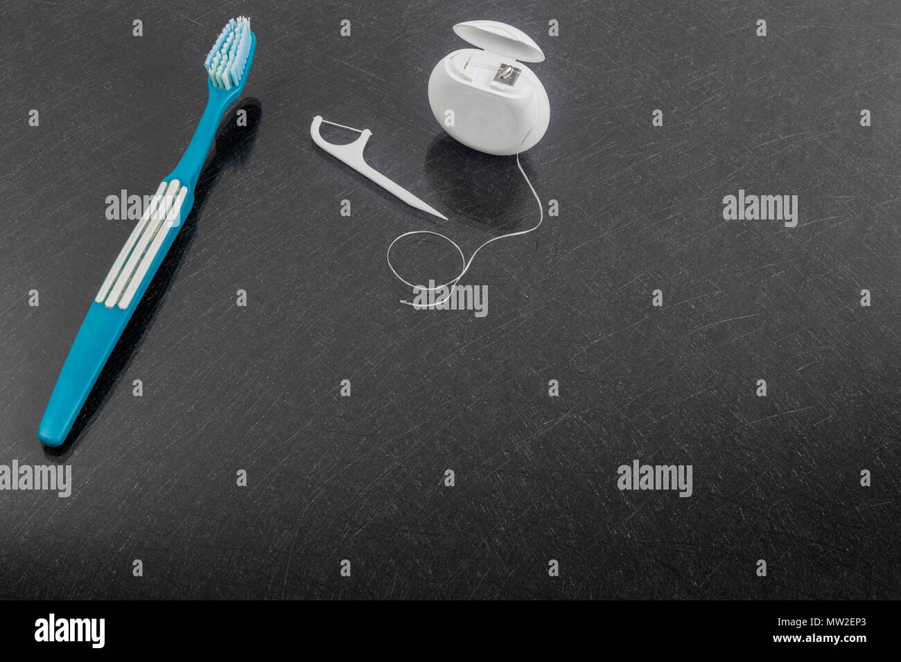 Dental floss and toothbrush on gray background Stock Photo - Alamy