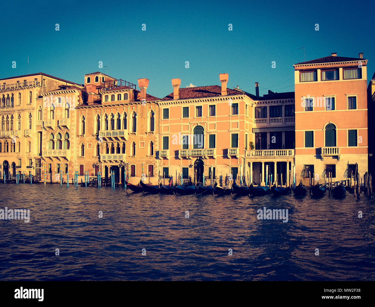 Gondolas glide along the Grand Canal in Venice, showcasing historic ...