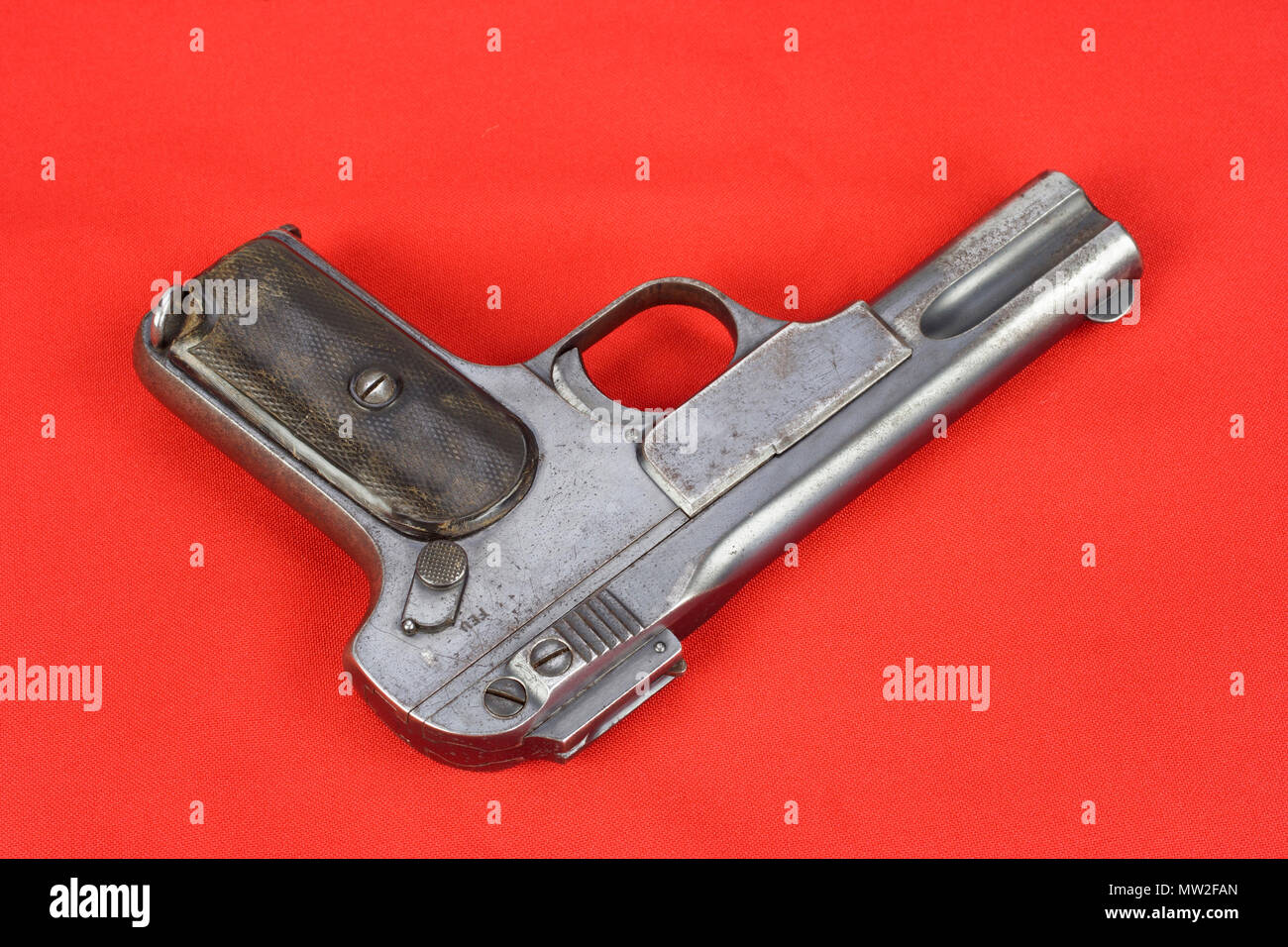 Old rusty handgun on red background Stock Photo - Alamy