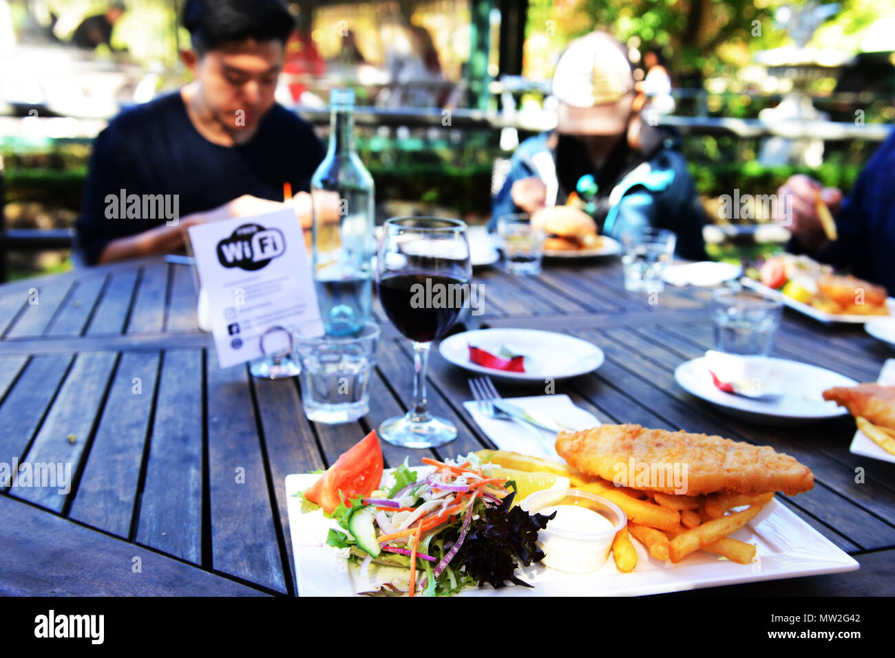 Tourist enjoying their lunch and local wine at the restaurant at the ...
