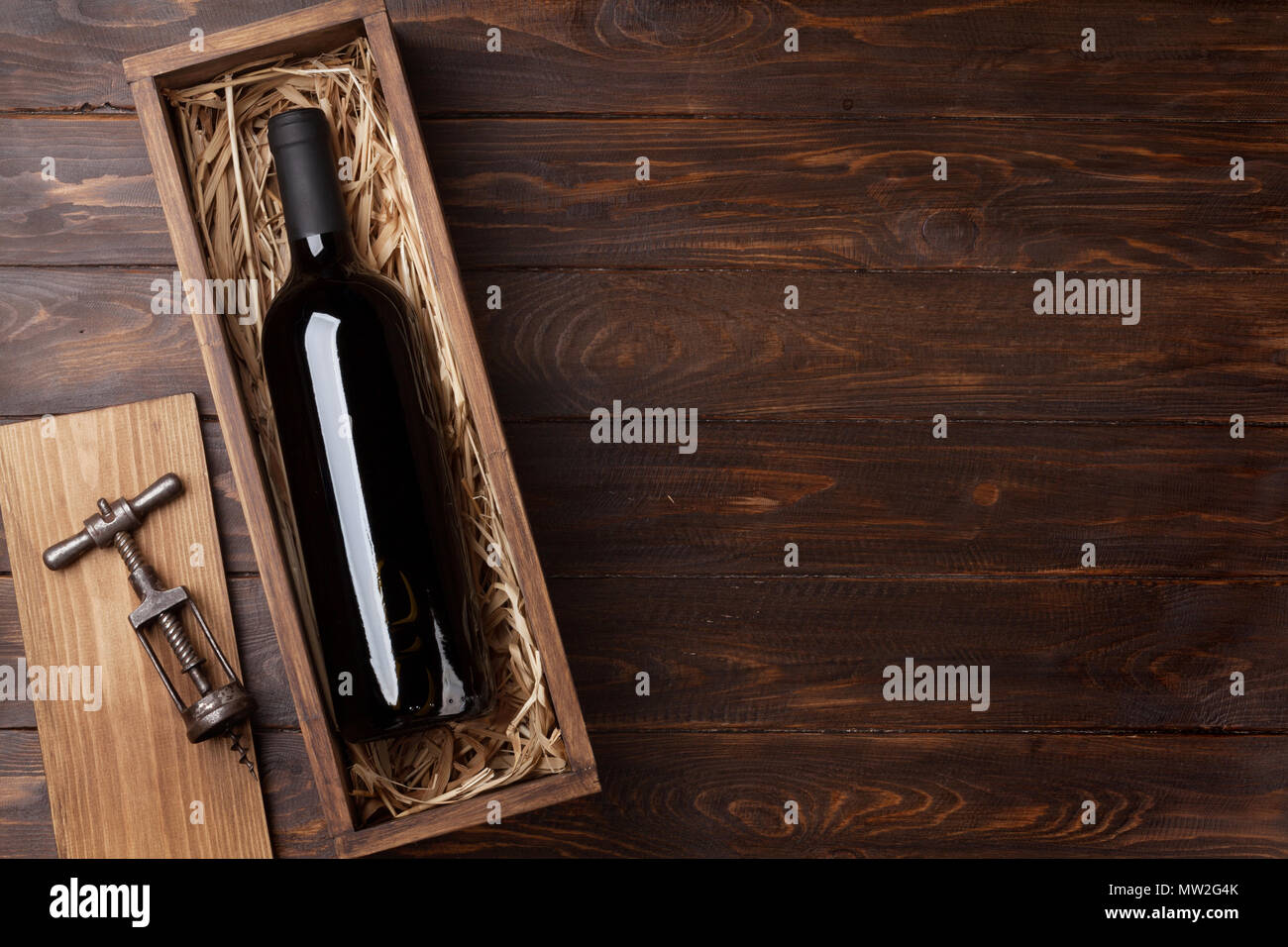 Red wine bottle in box on wooden table. Top view with space for your ...