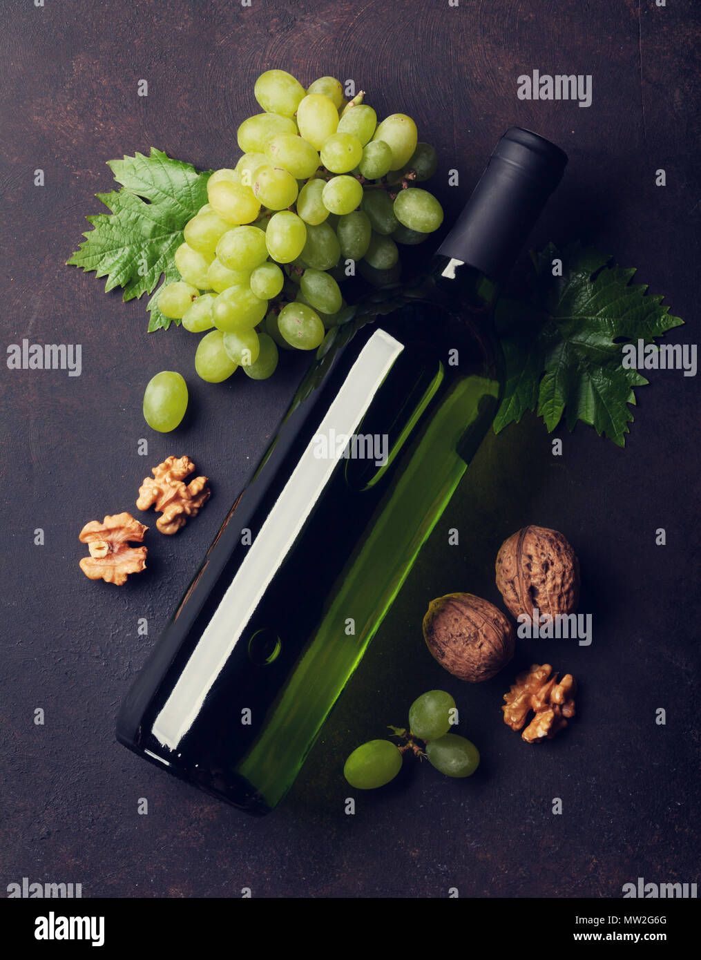 Wine bottle, grape and nuts. Top view. Toned Stock Photo - Alamy
