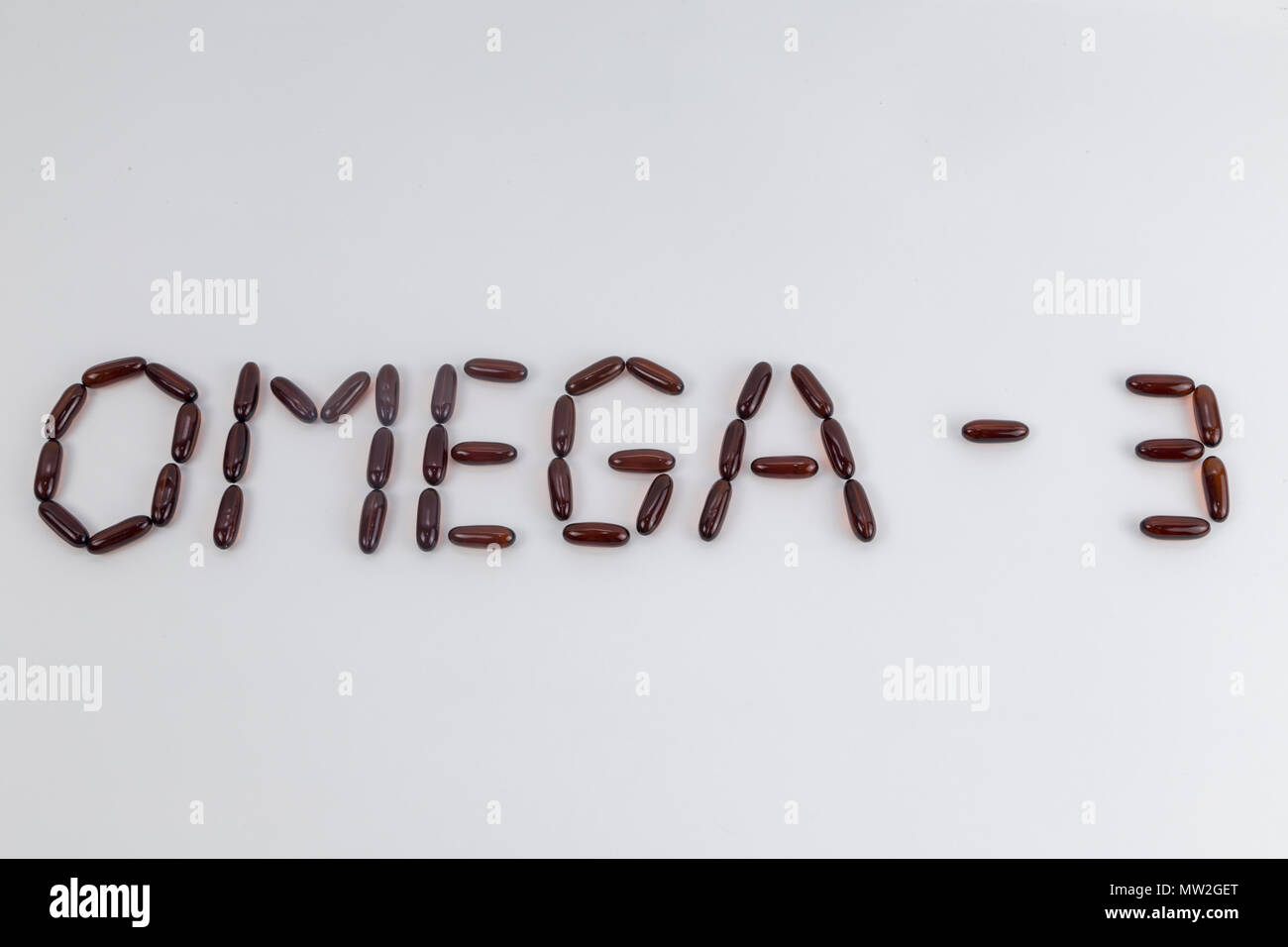 Word OMEGA 3 made of cod liver oil capsules on white background Stock ...