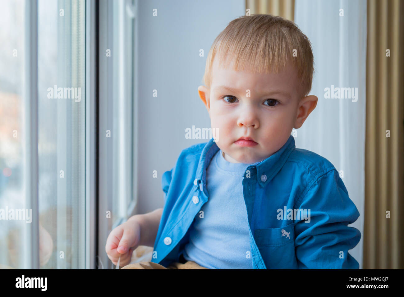 Portrait of pensive little boy near window, childhood Stock Photo - Alamy
