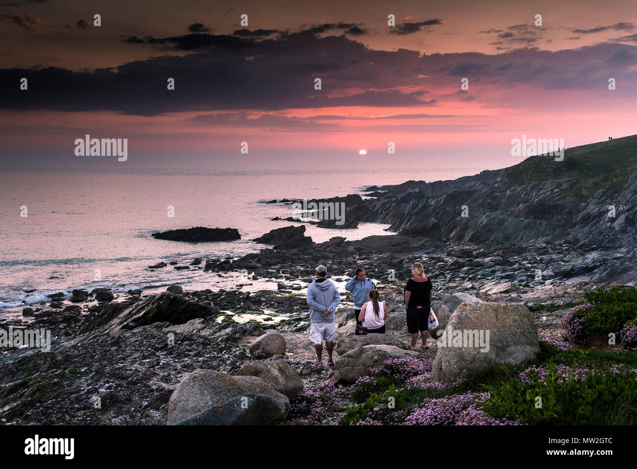 Holidaymakers watching a beautiful sunset at Little Fistral in Newquay ...