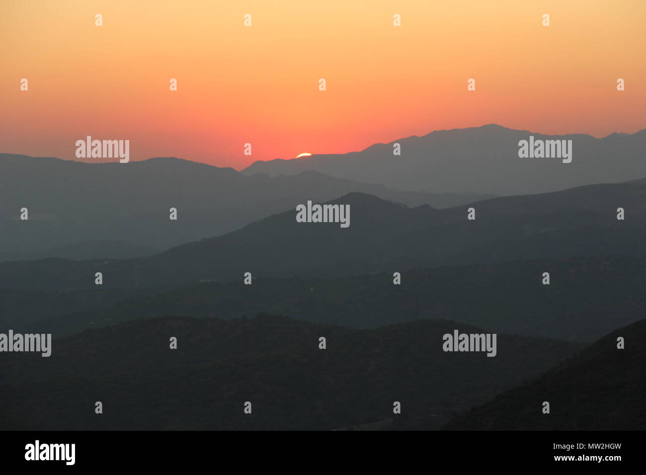 Sunset over the mountains Stock Photo - Alamy