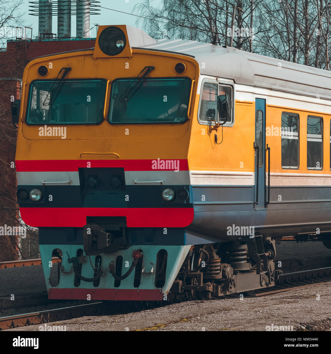 Old yellow passenger diesel train moving at the terminal Stock Photo ...