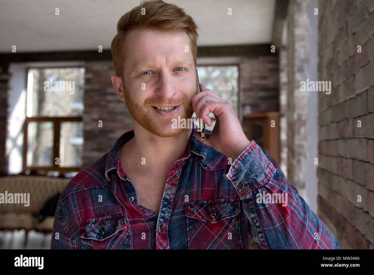 Gorgeous boy talking over phone in his room. Portrait of charming young ...