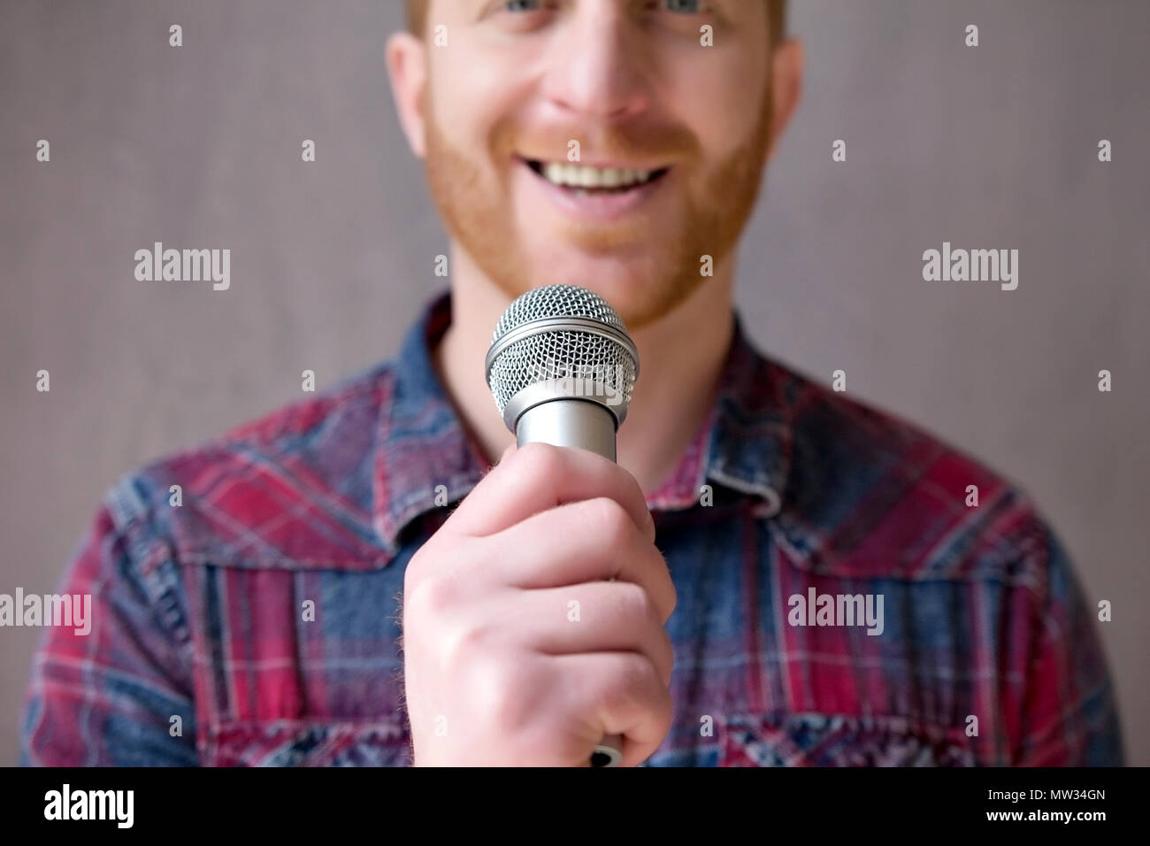 Handsome guy with microphone Stock Photo - Alamy