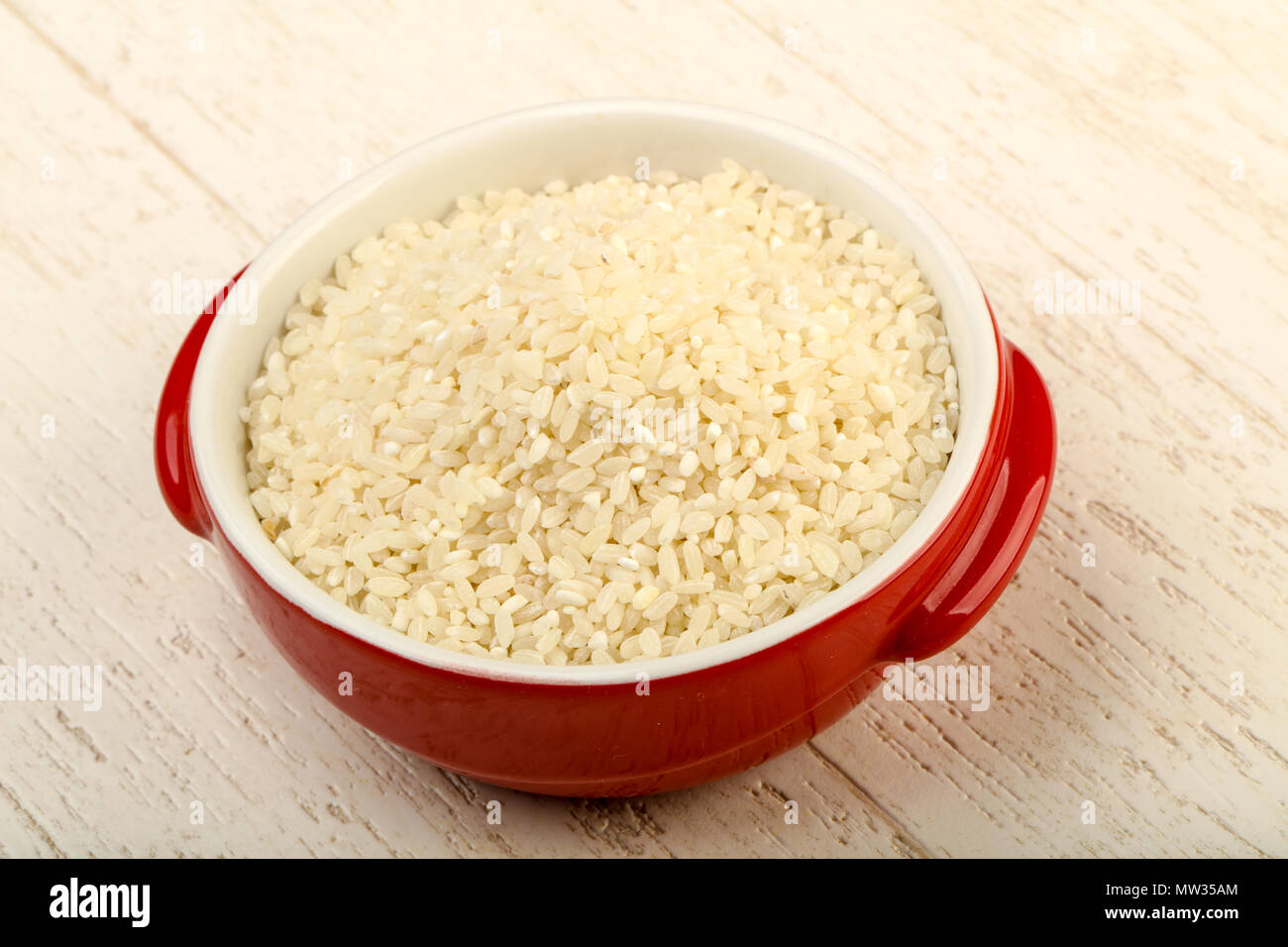 Raw rice heap in the bowl - ready for cooking Stock Photo - Alamy