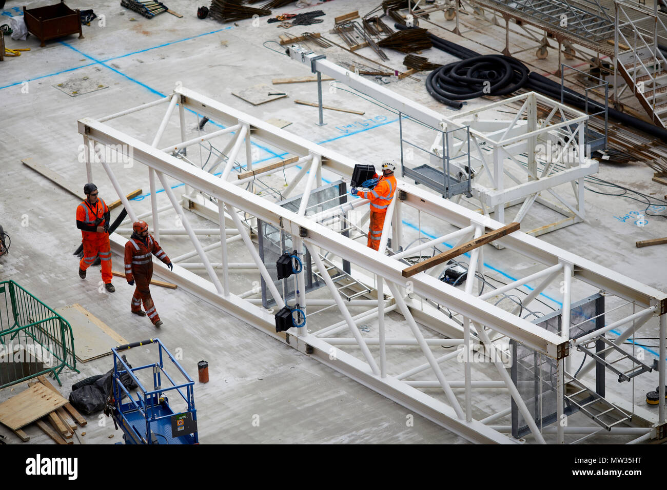 Construction workers building the tower crane at Sir Henry Royce ...