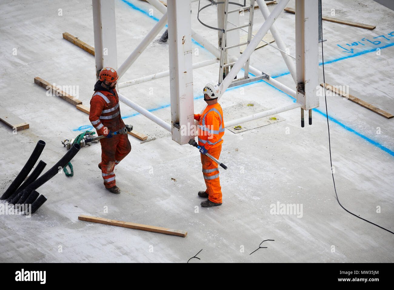 Construction workers building the tower crane at Sir Henry Royce ...