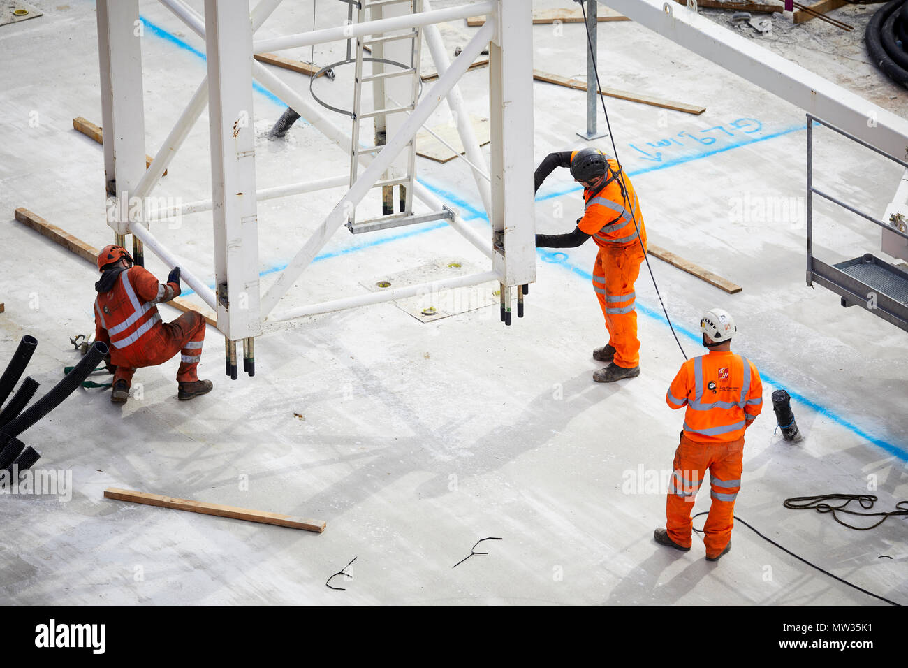 Construction workers building the tower crane at Sir Henry Royce ...