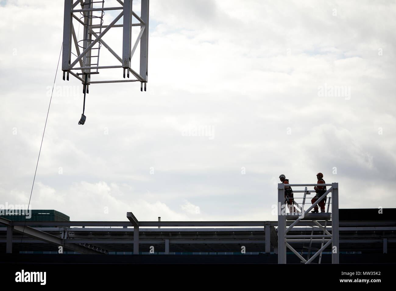 Construction workers building the tower crane at Sir Henry Royce ...