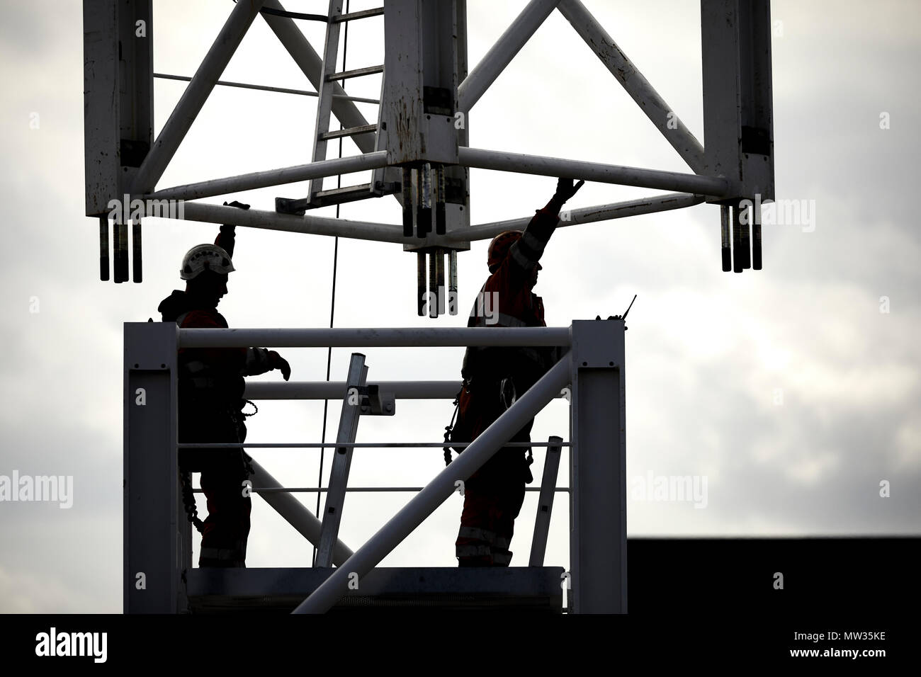 Construction workers building the tower crane at Sir Henry Royce ...