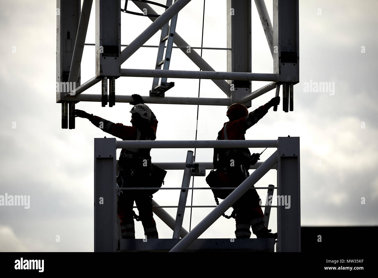 Construction workers building the tower crane at Sir Henry Royce ...