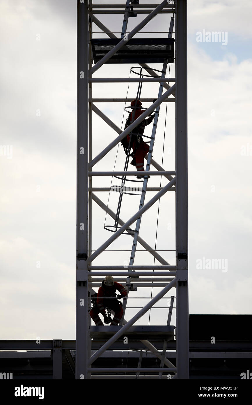 Construction workers building the tower crane at Sir Henry Royce ...