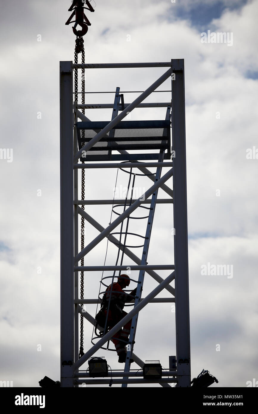 Construction workers building the tower crane at Sir Henry Royce ...