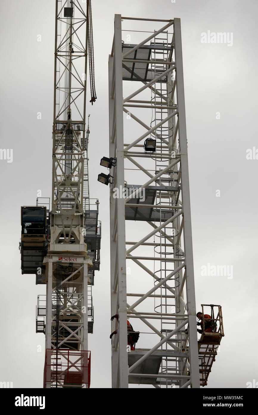 Construction workers building the tower crane at Sir Henry Royce ...