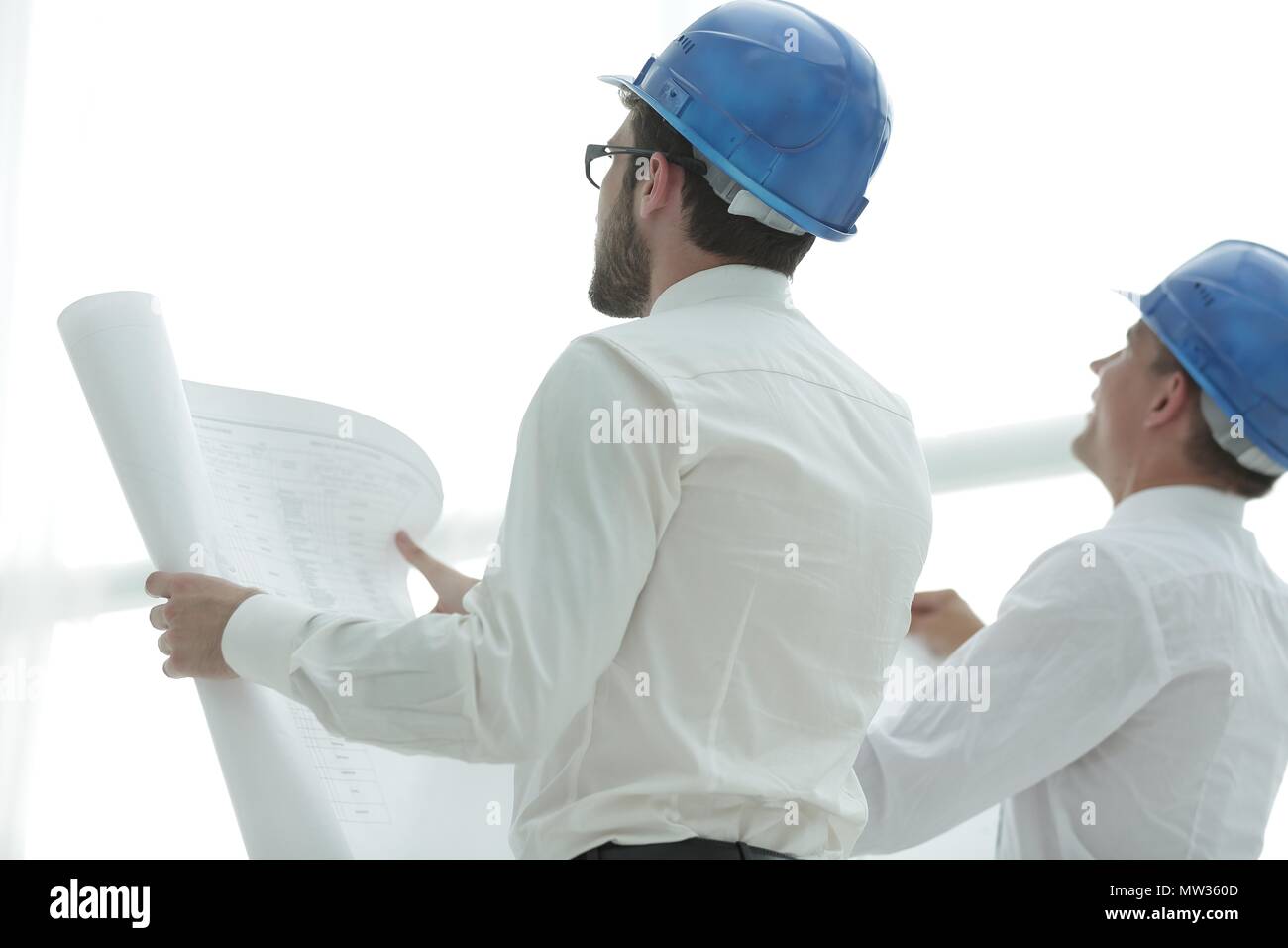 rear view.architect and Builder looking at blank screen Stock Photo - Alamy