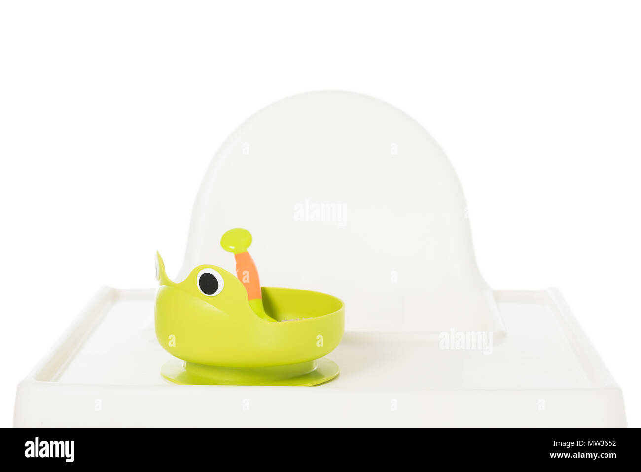 plate in form of frog with baby food on highchair isolated on white ...