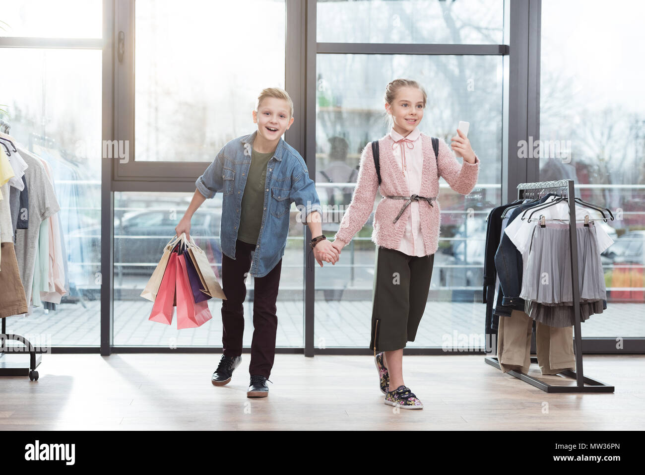 happy children with shopping bags making selfie at shop Stock Photo - Alamy