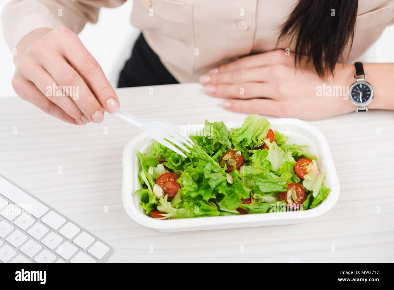 overhead view of businesswoman with take away food at workplace in ...