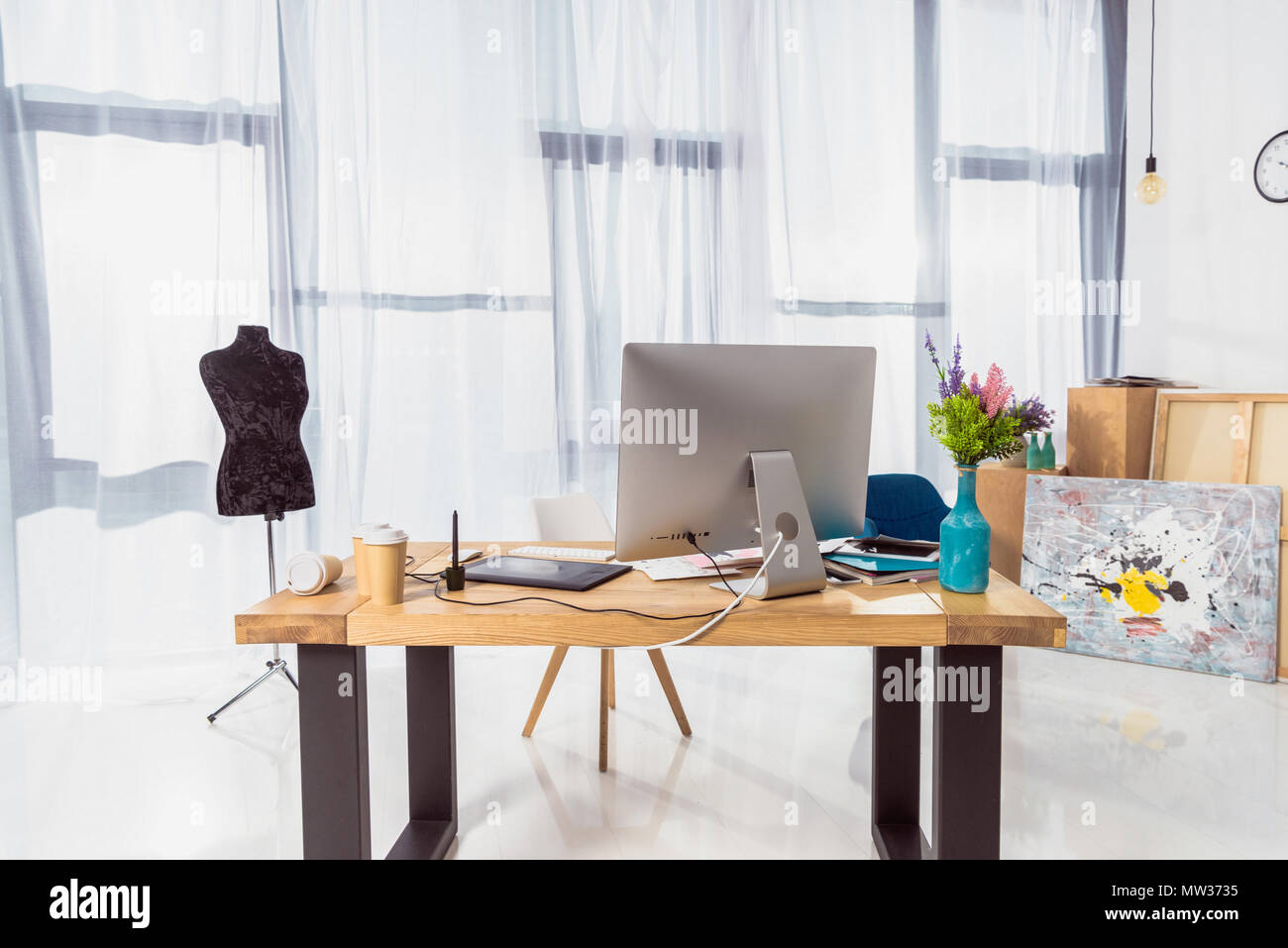 Work place of designer with tailor dummy and computer Stock Photo - Alamy