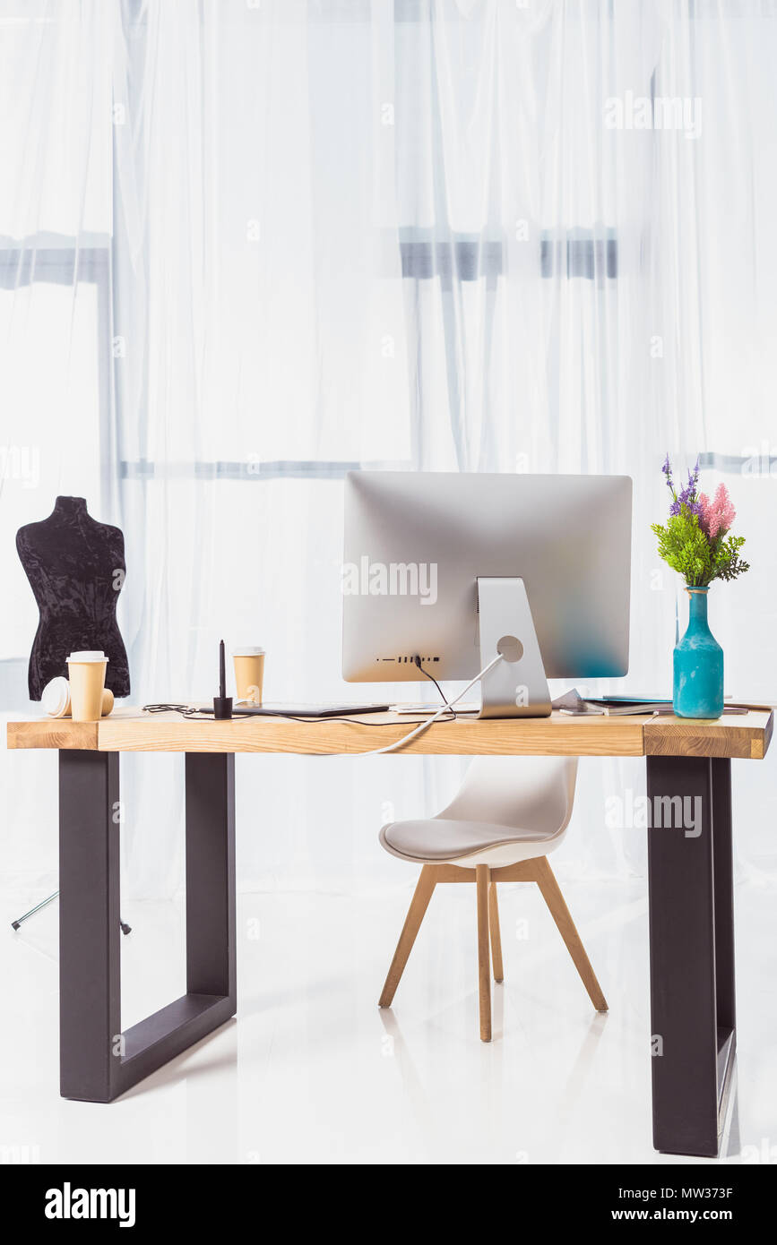 Work place of designer with tailor dummy and computer Stock Photo - Alamy