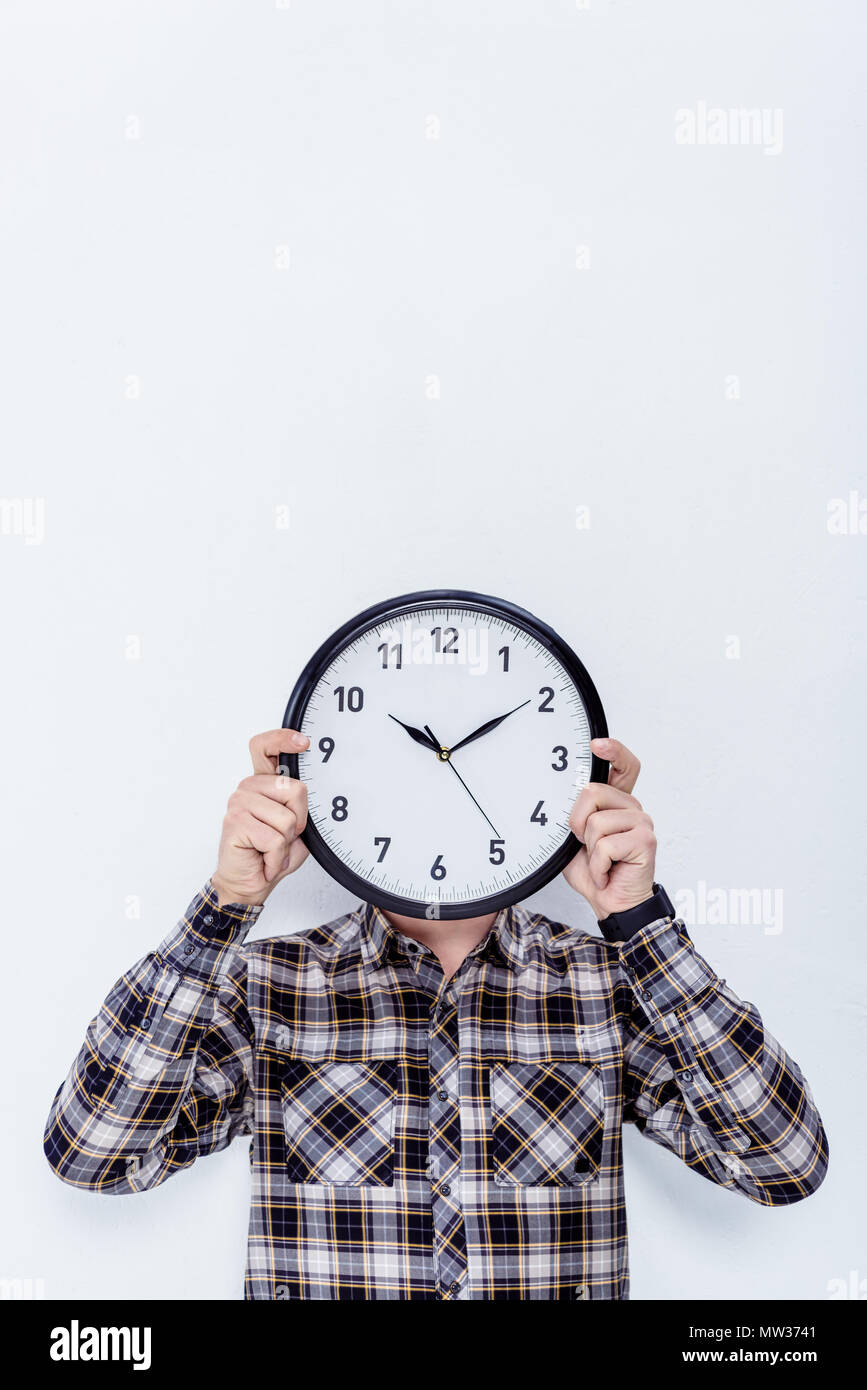 Clock in male hands over his face isolated on white Stock Photo - Alamy