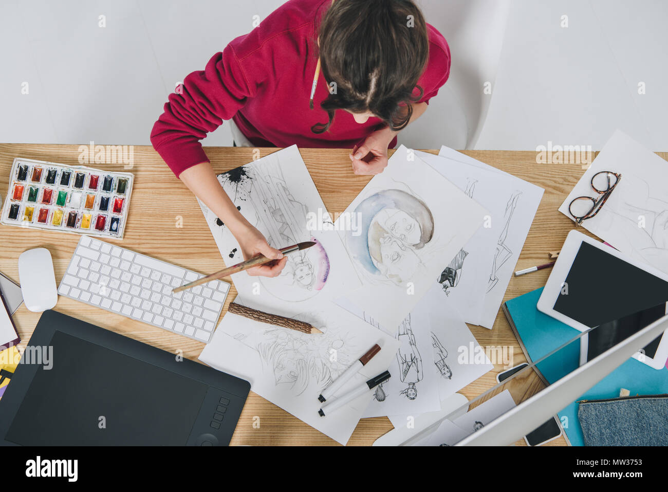 Attractive young girl drawing by table with computer Stock Photo - Alamy