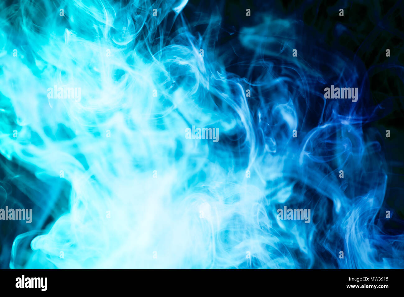 Thick colorful blue smoke on a black isolated background. Background ...