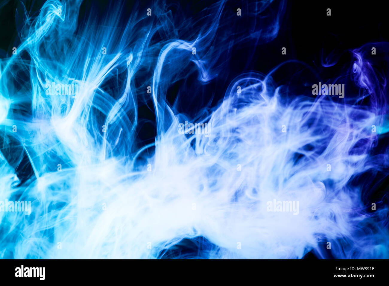 Thick colorful blue smoke on a black isolated background. Background ...
