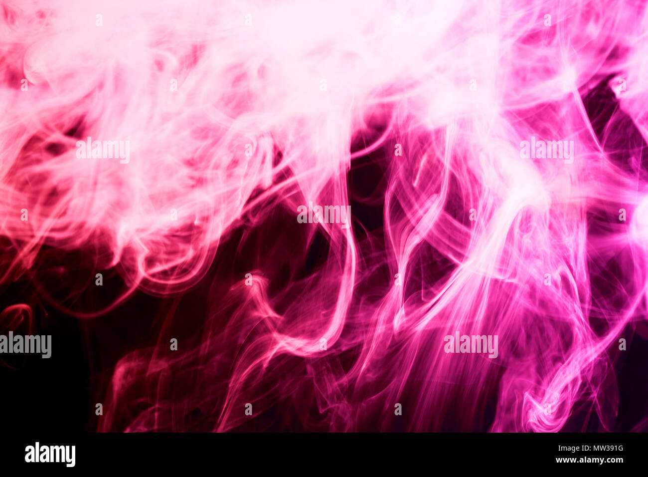 Thick colorful pink smoke on a black isolated background. Background ...