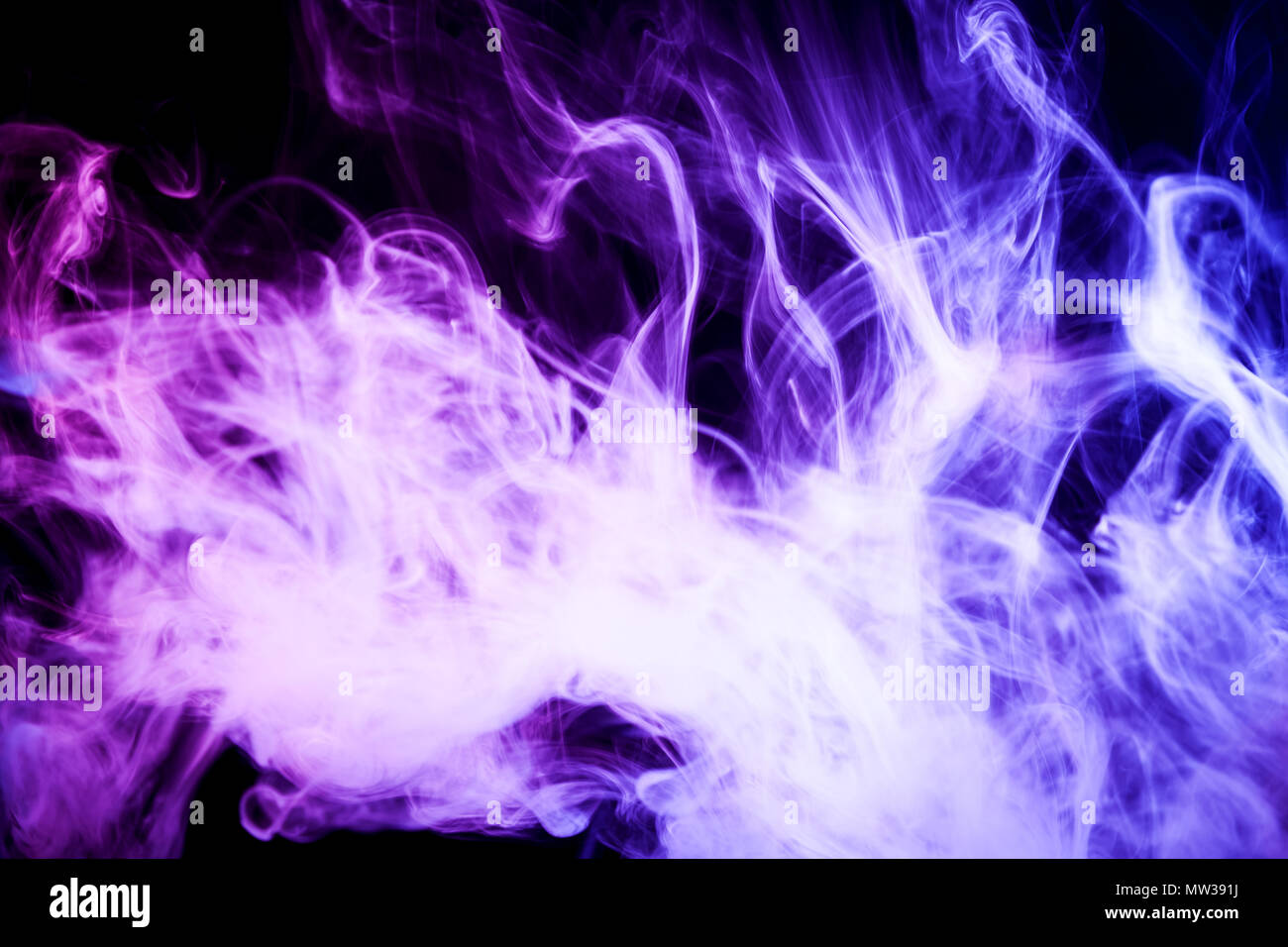 Thick colorful purple smoke on a black isolated background. Background ...