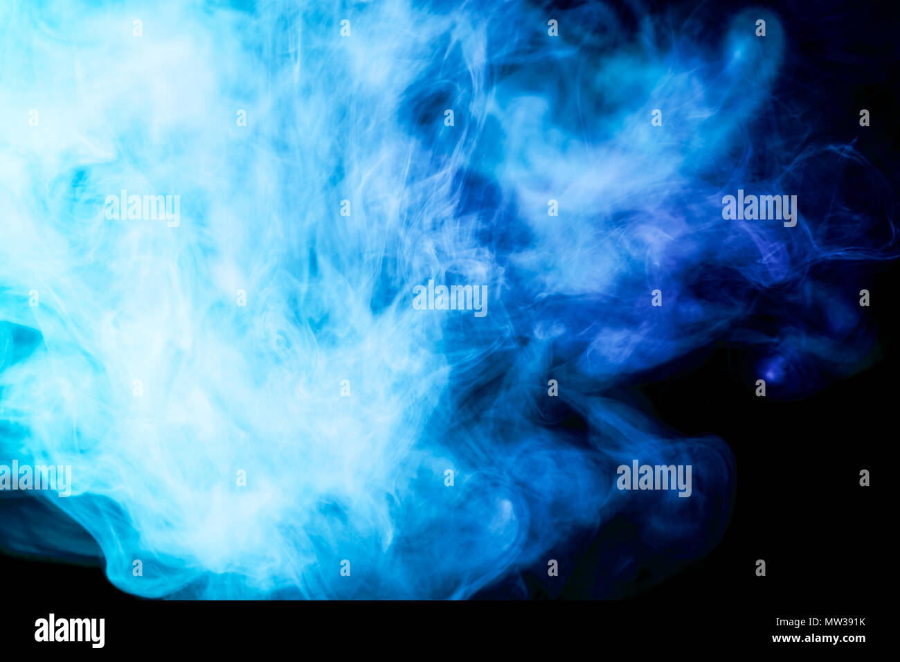 Thick colorful blue smoke on a black isolated background. Background ...